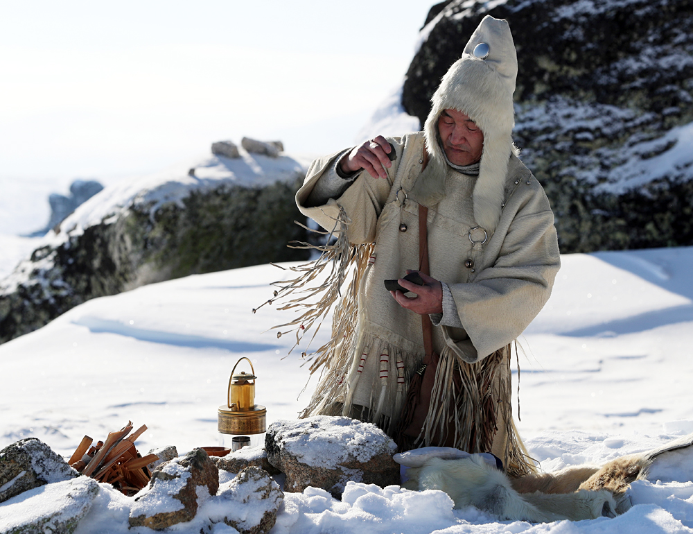 A shaman lighting the Children of Asia International Sports Games torch ...